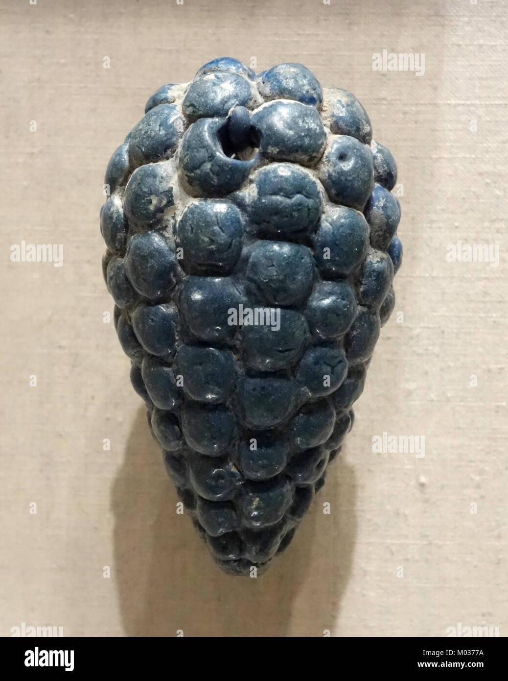 This artifact, a faience representation of a bunch of grapes, is from ...