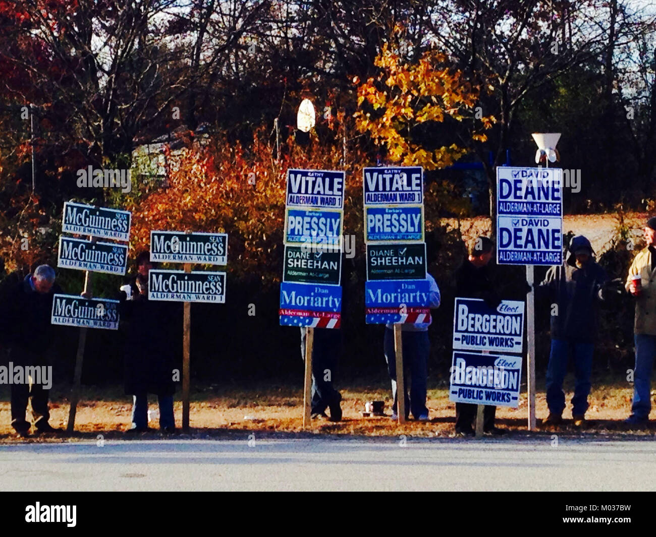 This image shows supporters holding placards for a political candidate ...