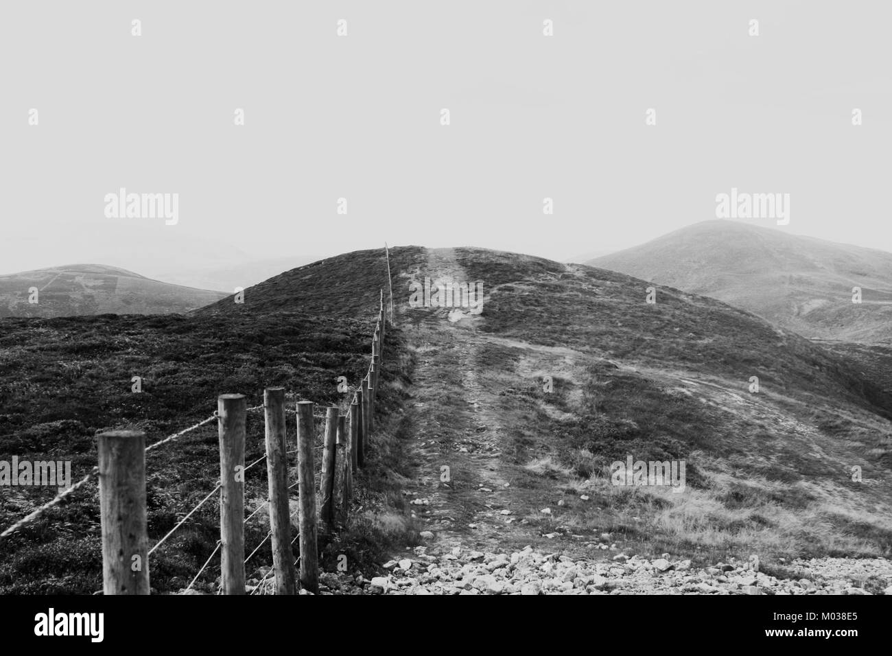 This image shows a path leading to a hilltop with a fence along the way ...