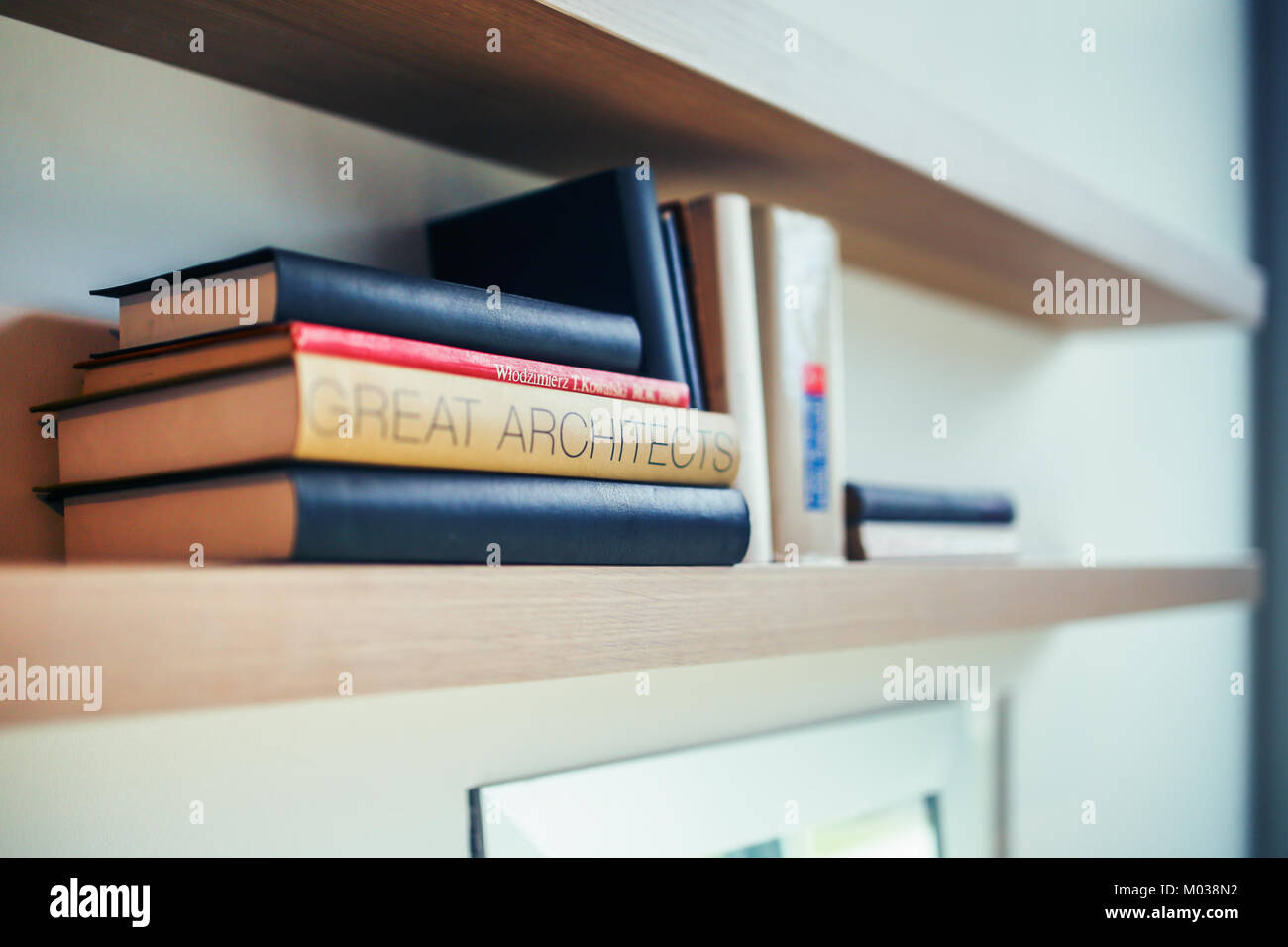 The image features a shelf filled with books, likely part of an ...