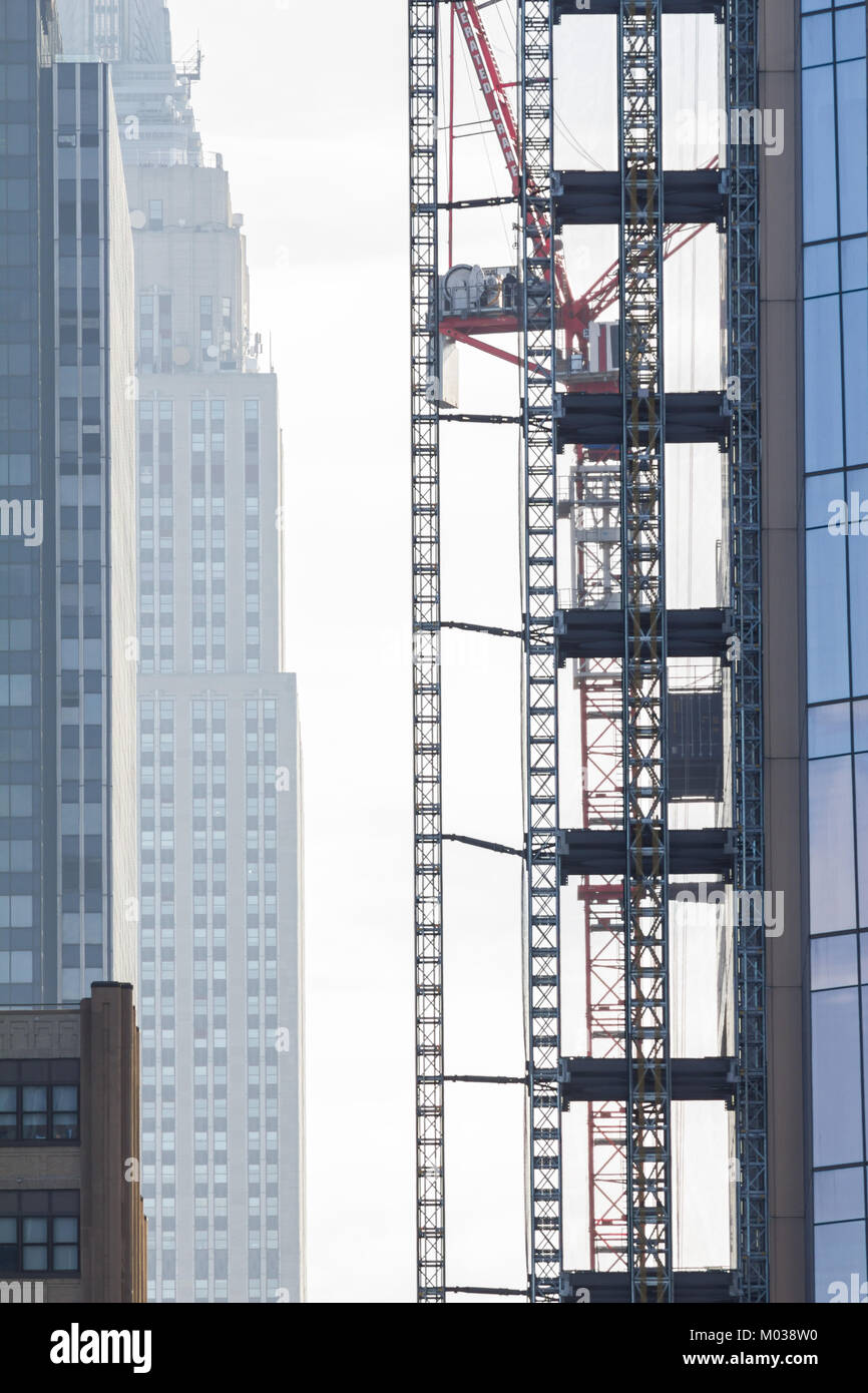 Construction with skyscraper - high-rise building with tall crane Stock ...