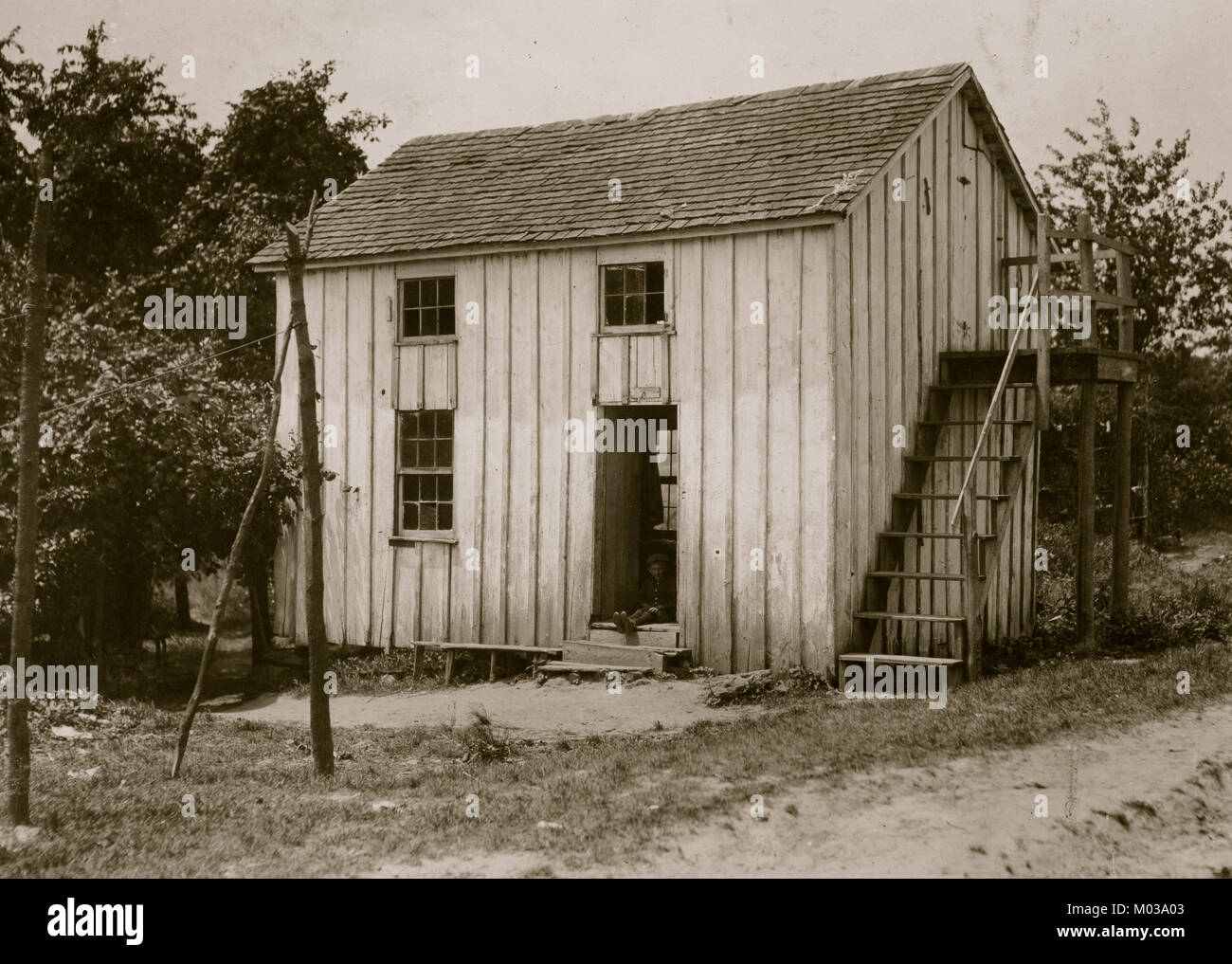 Three families live in this shack: one room above and one below ...