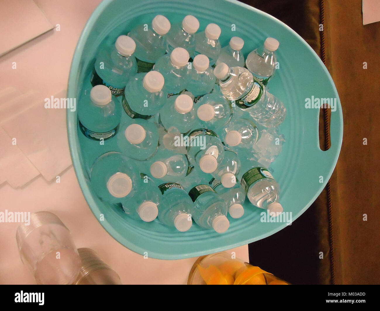 This image shows bottled water stored in a container filled with ice ...