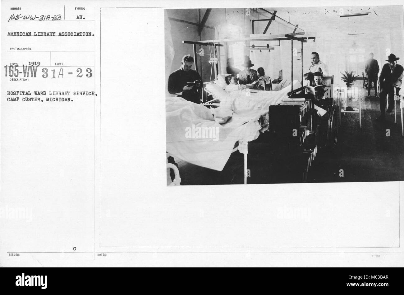 A historic photograph of a hospital ward at Camp Custer, providing a ...