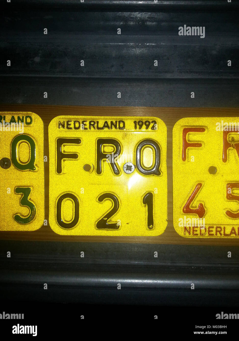 This image features a bromfietsplaatje, a small commemorative plaque ...