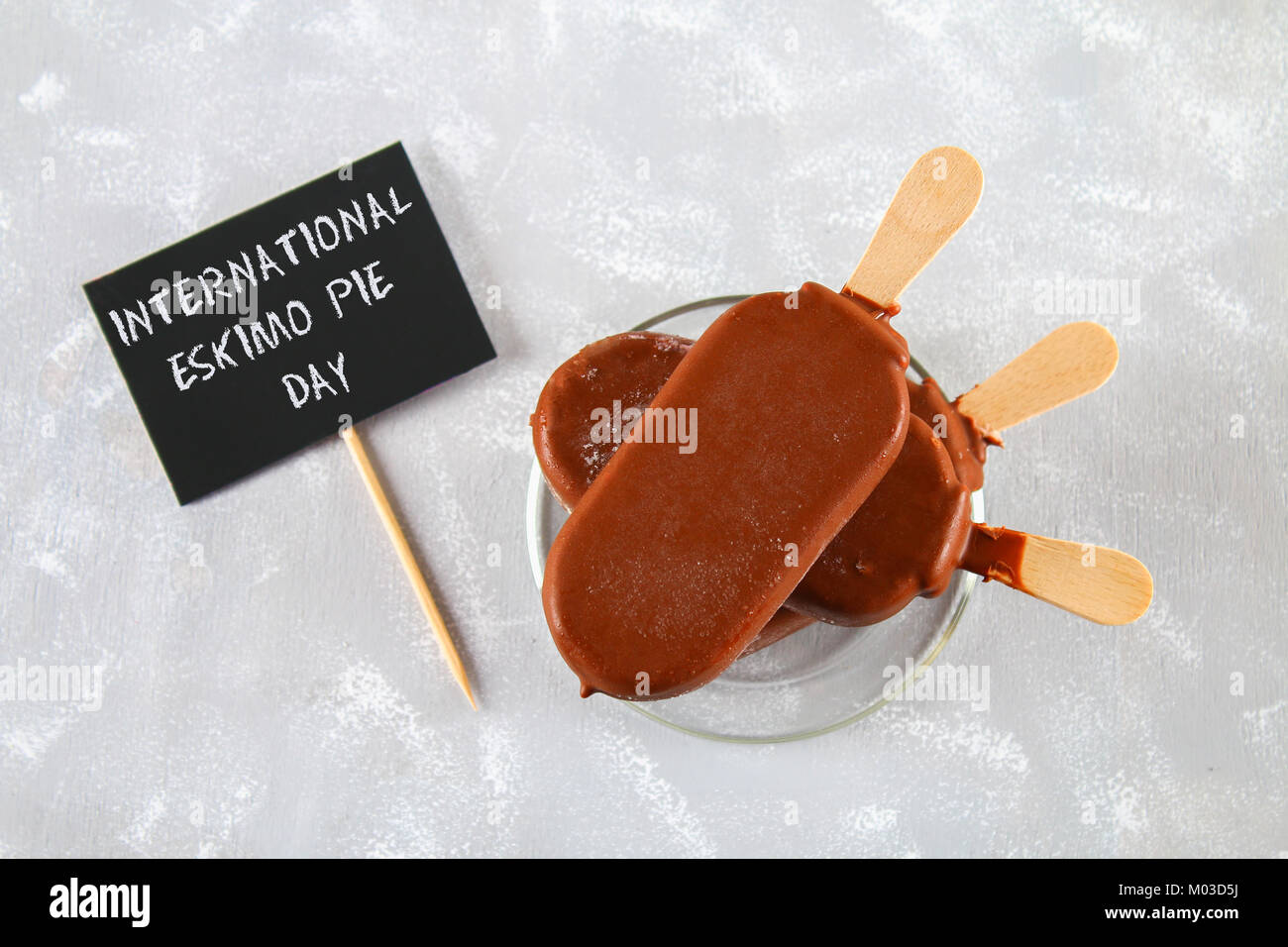 Ice cream eskimo pie on a stick with text on a gray background. Concept ...