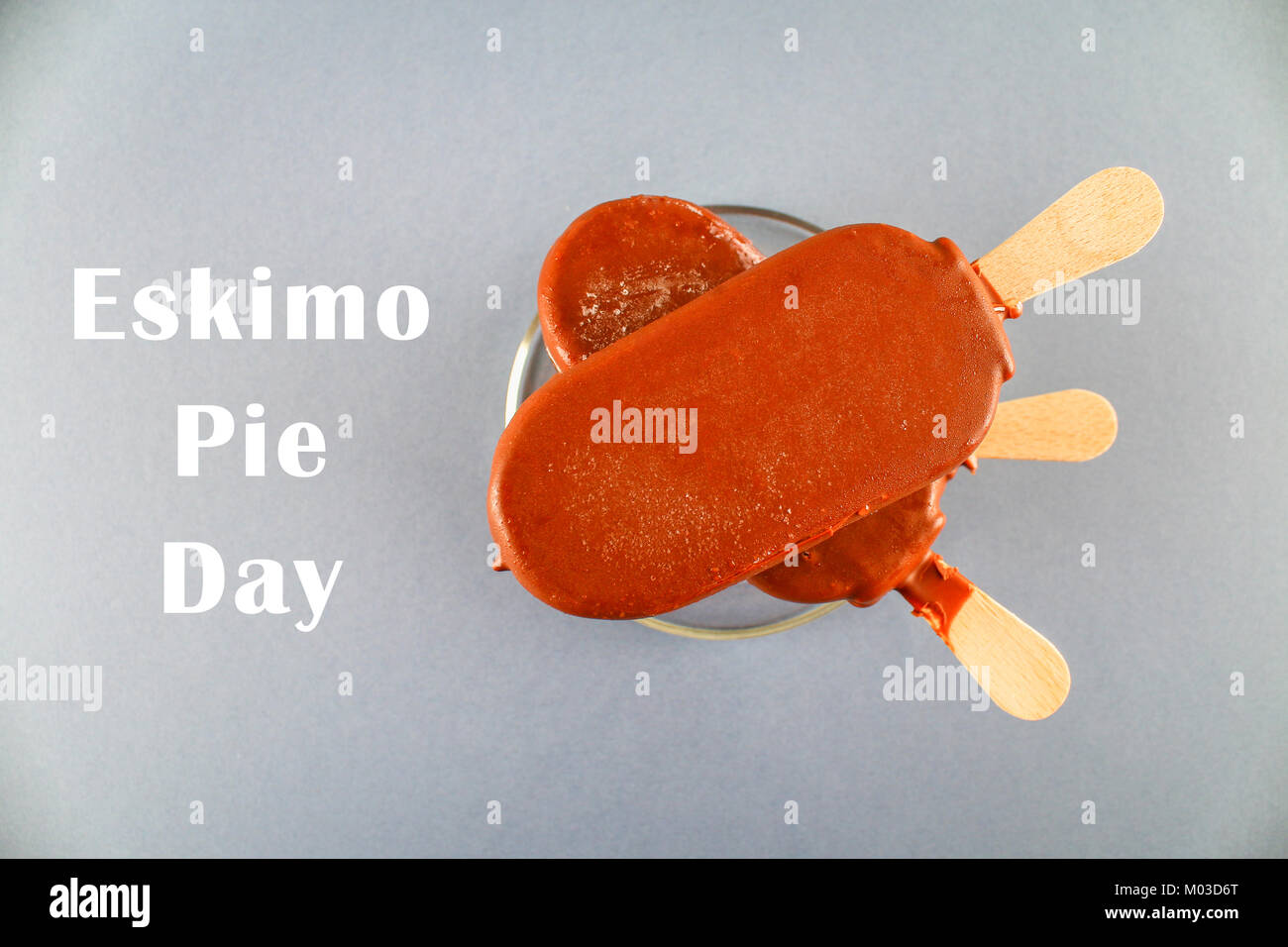 Ice cream eskimo pie on a stick with text on a gray background. Concept ...