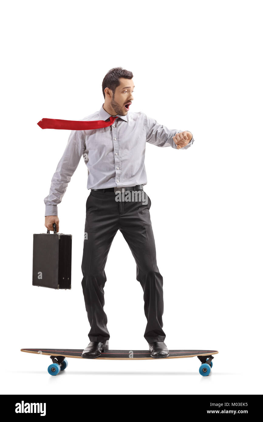 Full length profile shot of a businessman riding a longboard and ...