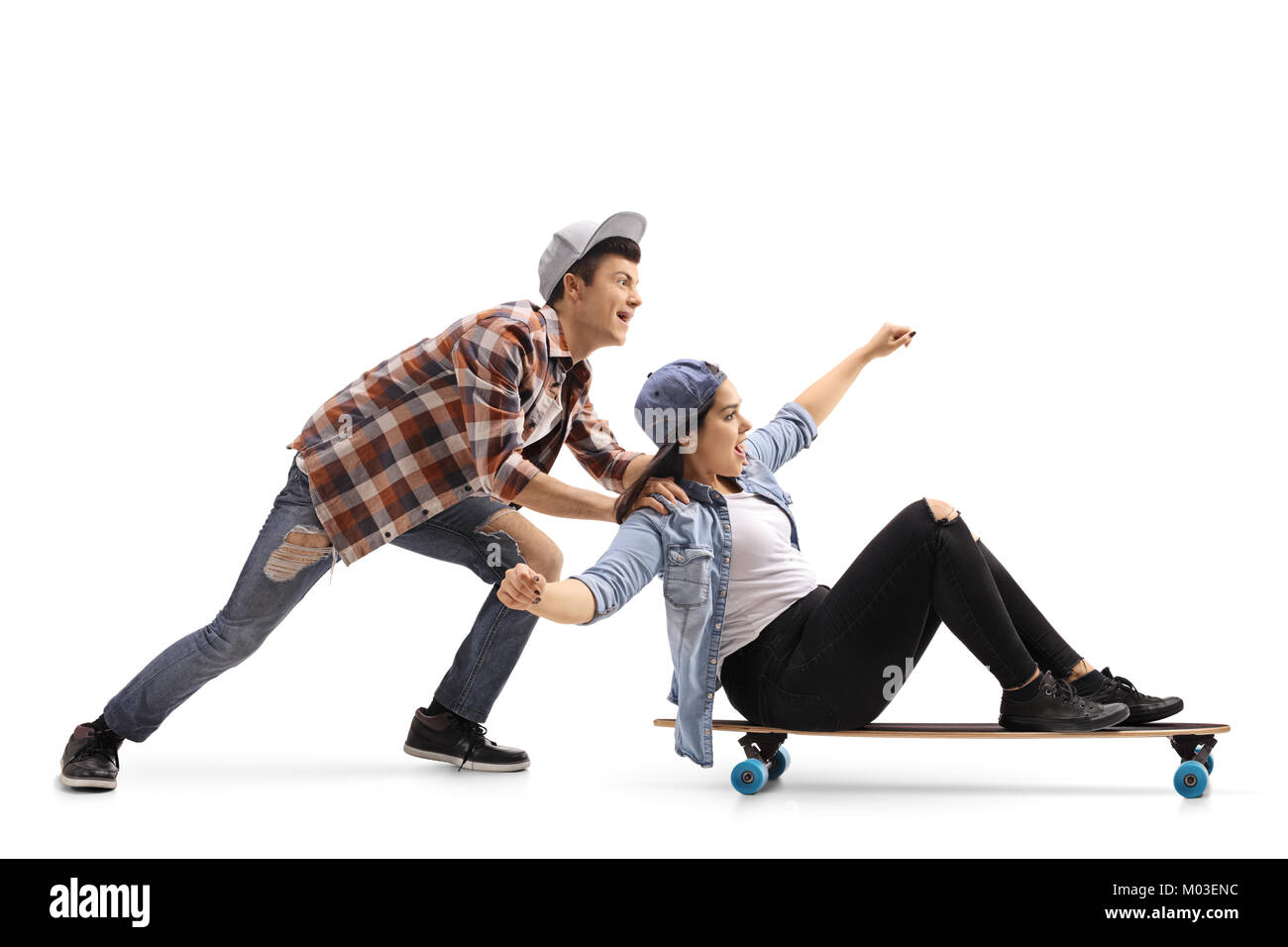 Teenage boy pushing a teenage girl on a longboard isolated on white ...