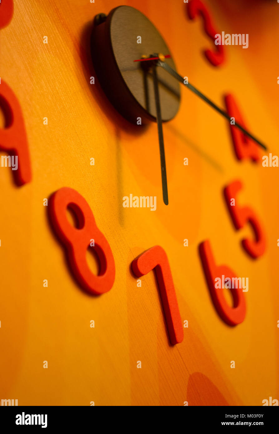 large wall clock with colorful numbers, close up Stock Photo - Alamy