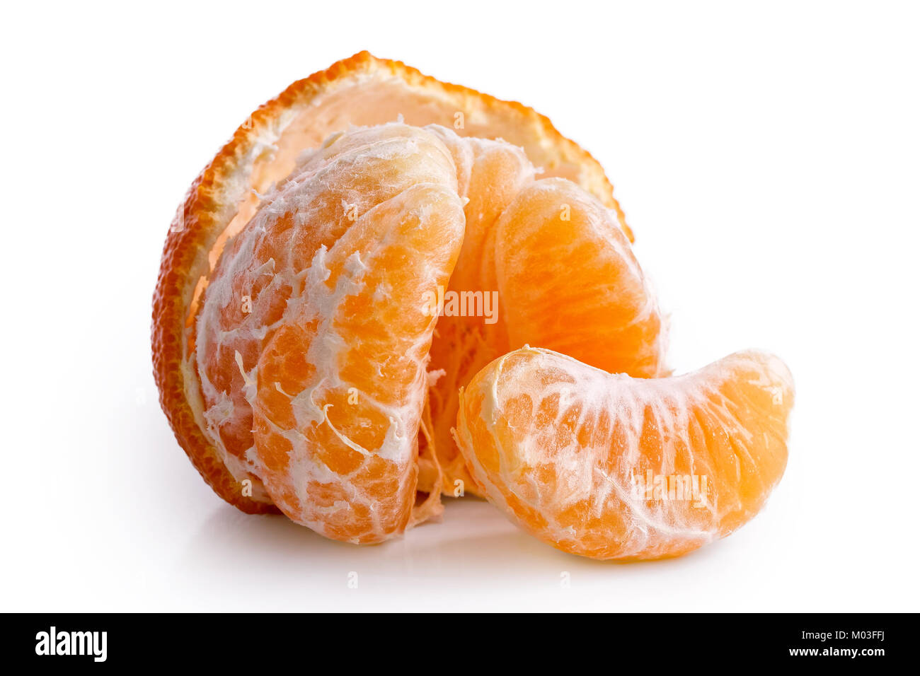 A half peeled mandarin split into segments isolated on white Stock ...