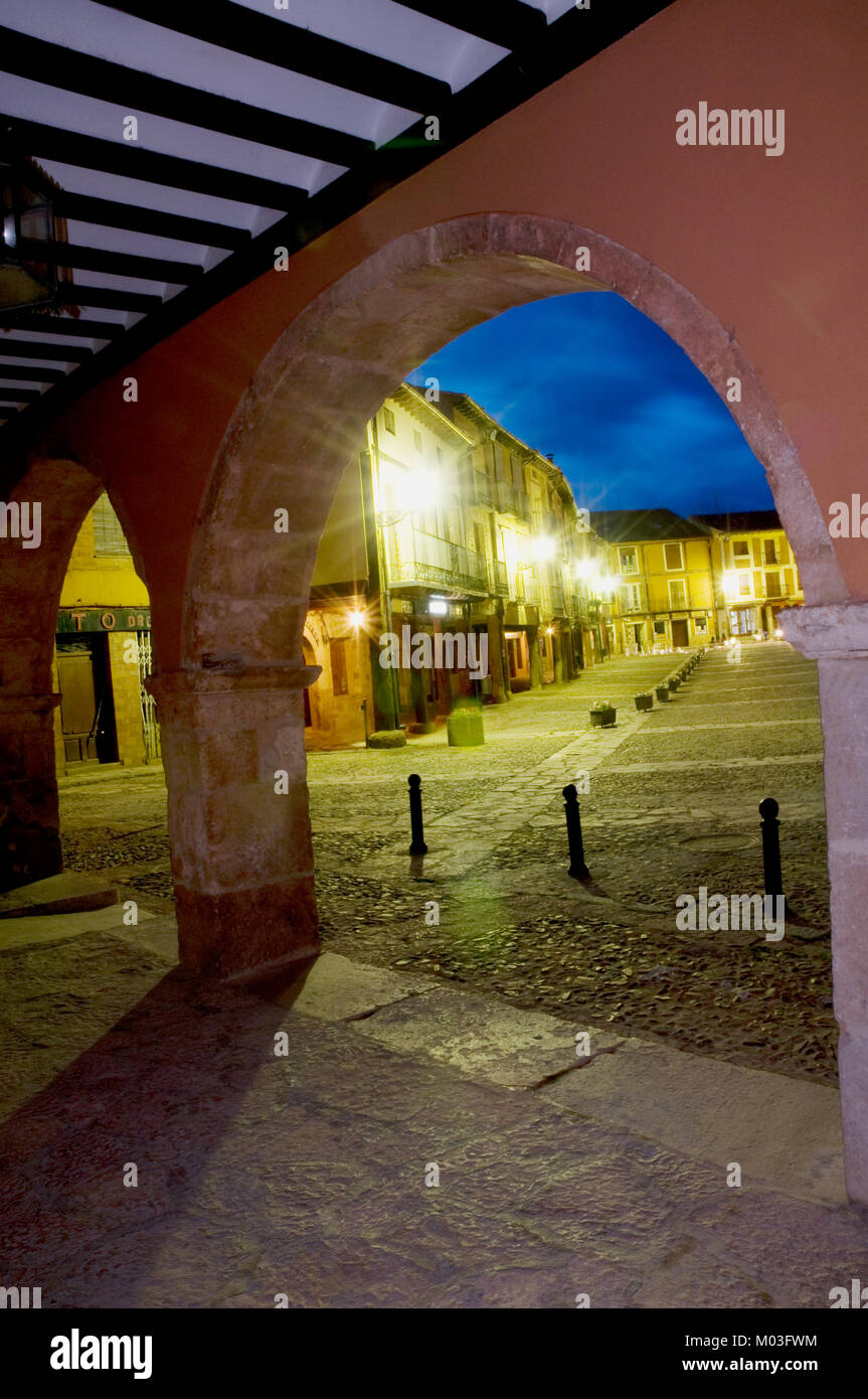 Plaza Mayor from the arcade, night view. Ayllon, Segovia province ...