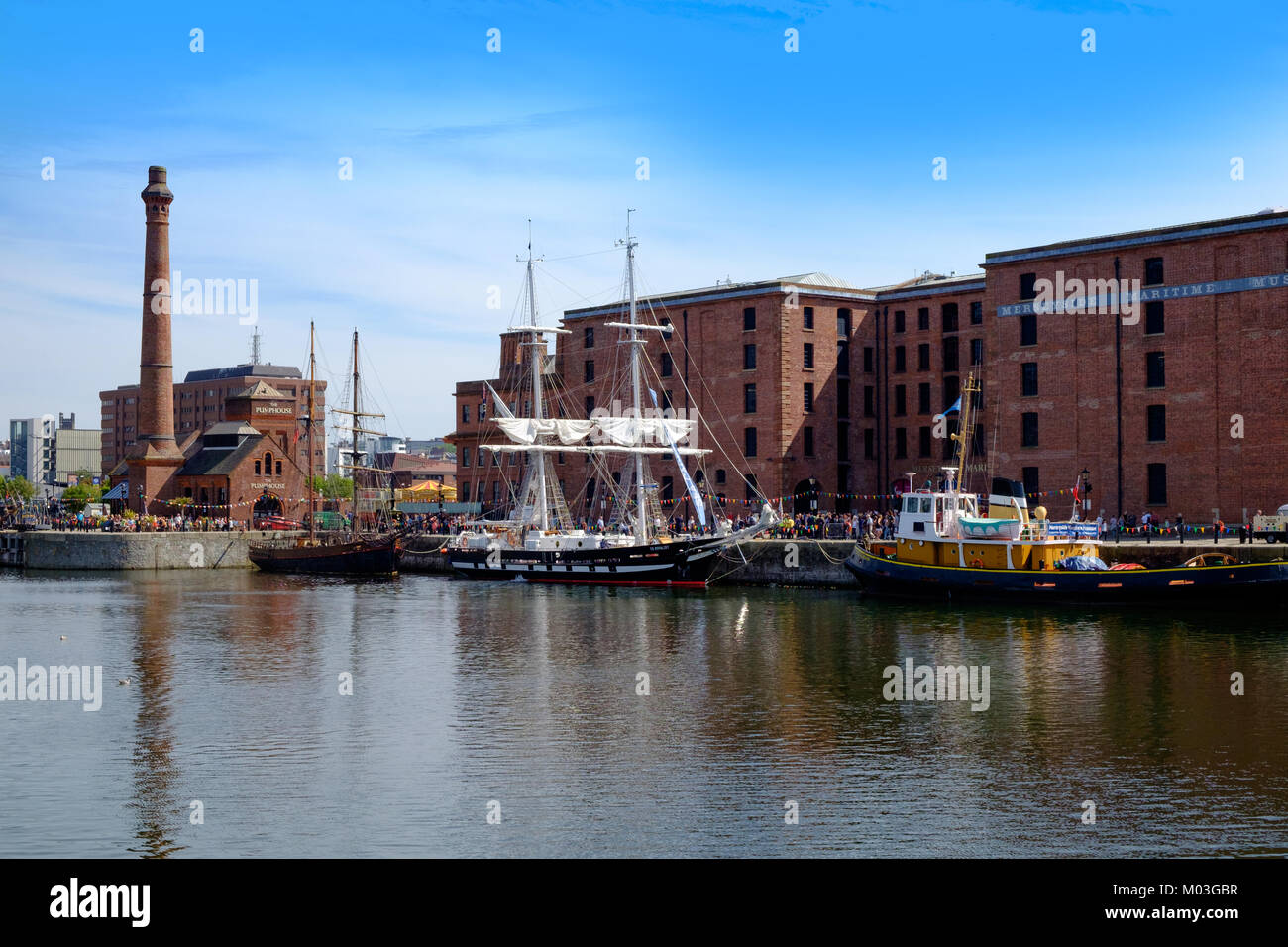 Liverpool dock with tall ship moored in harbour. The brig is Royalist ...