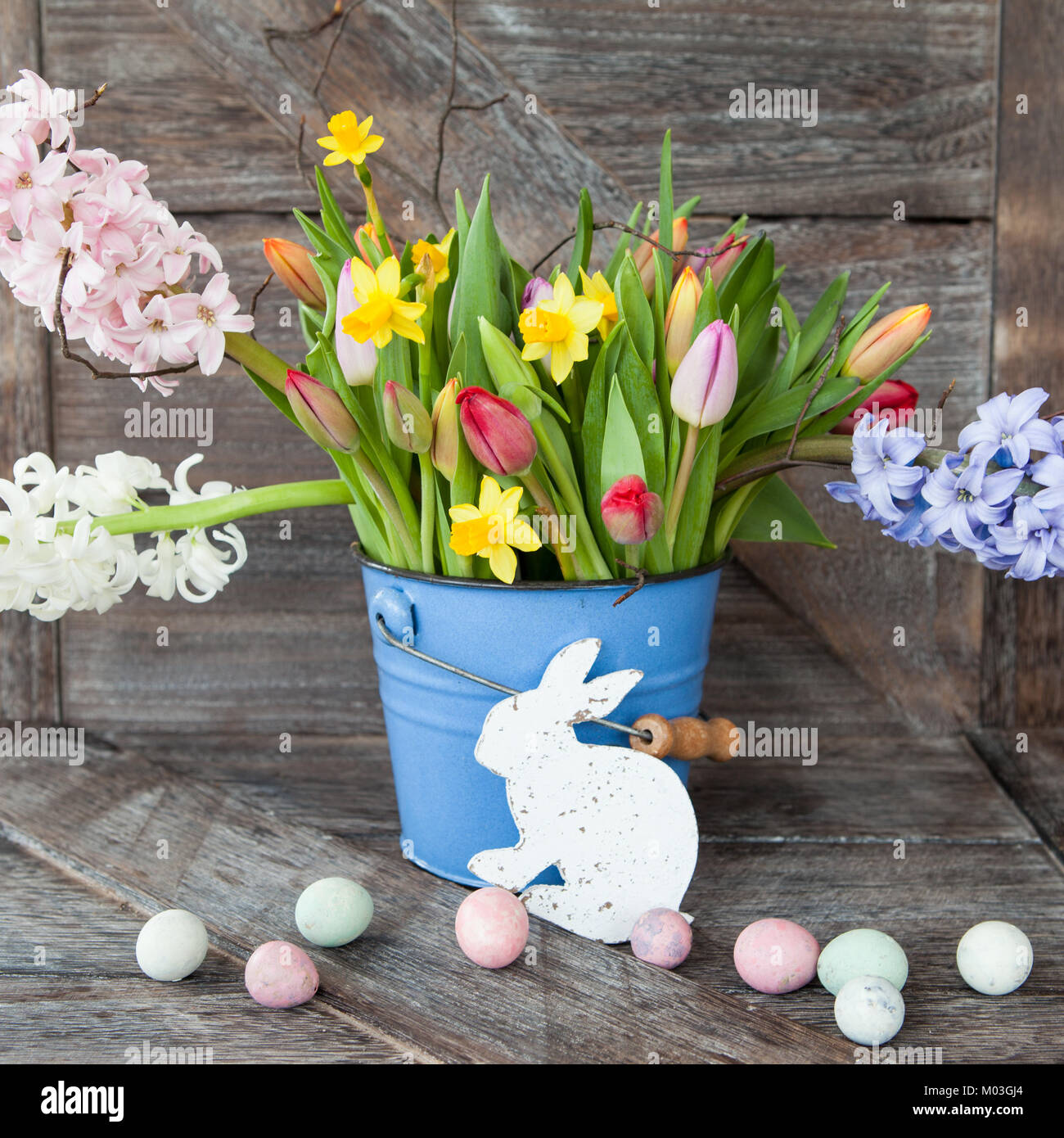 Colorful spring flowers in vintage blue bucket Stock Photo - Alamy