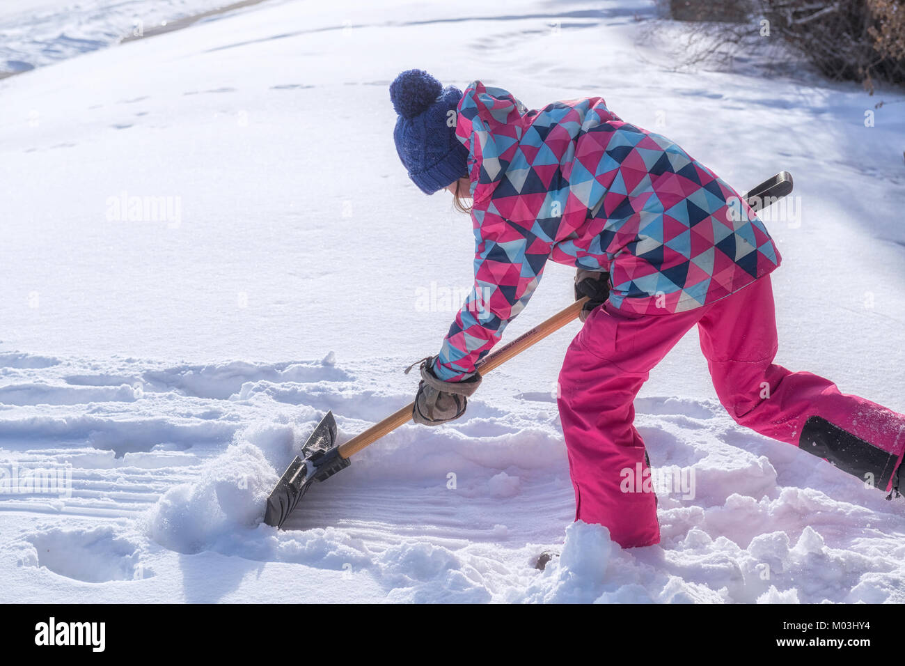 Young girl shovelling snow Stock Photo - Alamy