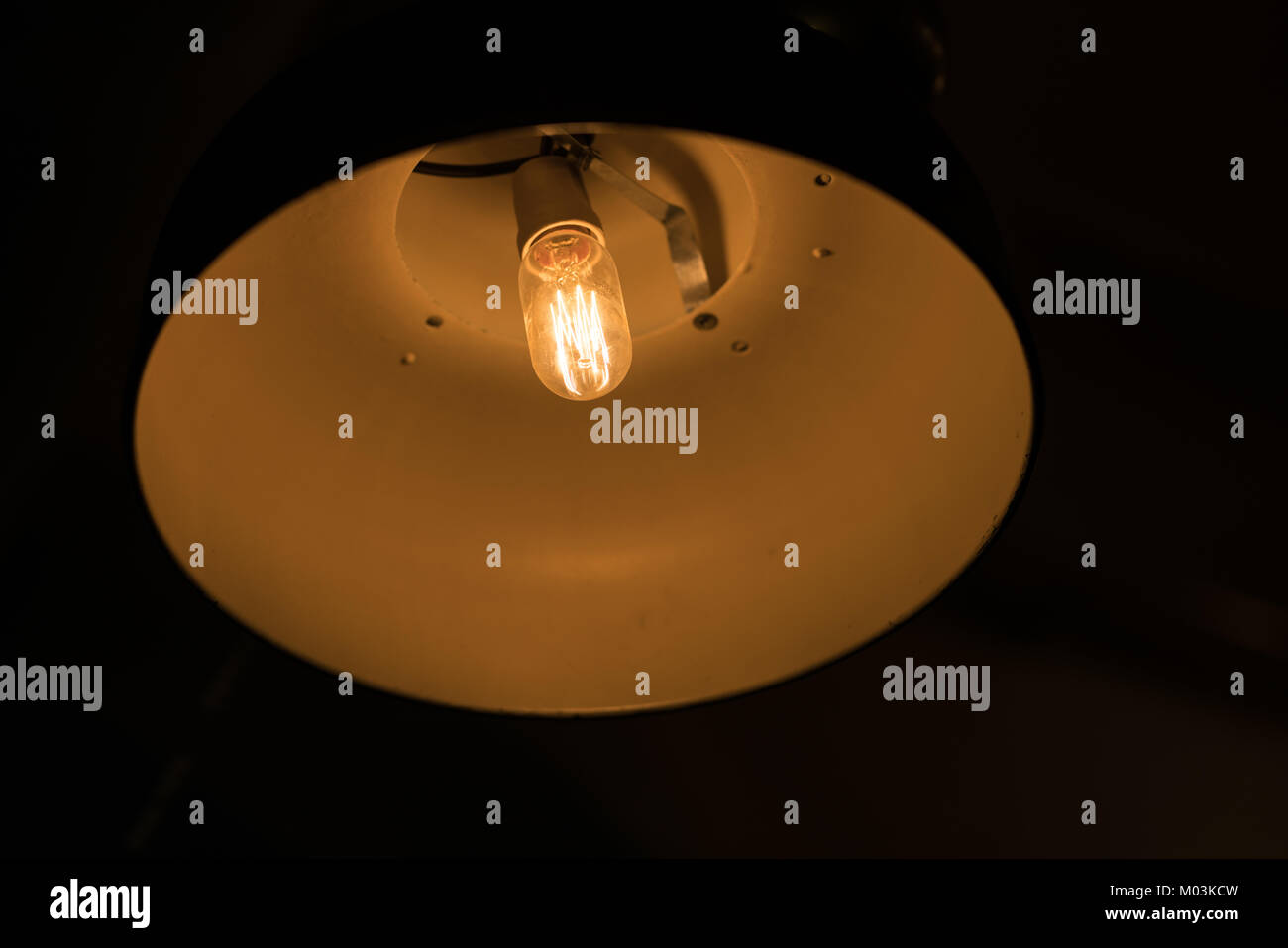Light bulb illuminated and taken from above and isolated against black ...