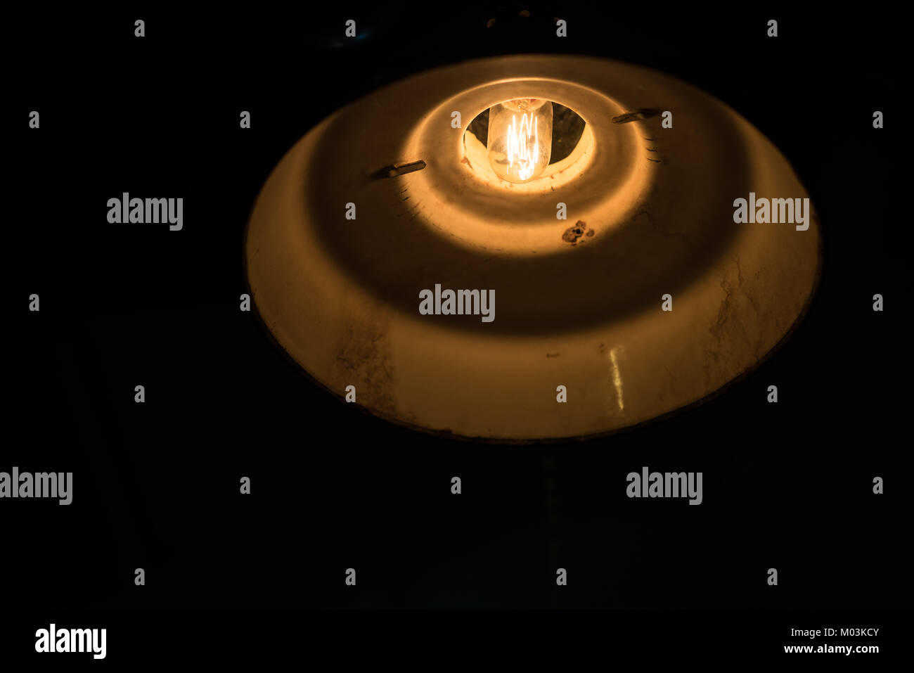Light bulb illuminated and taken from above and isolated against black ...