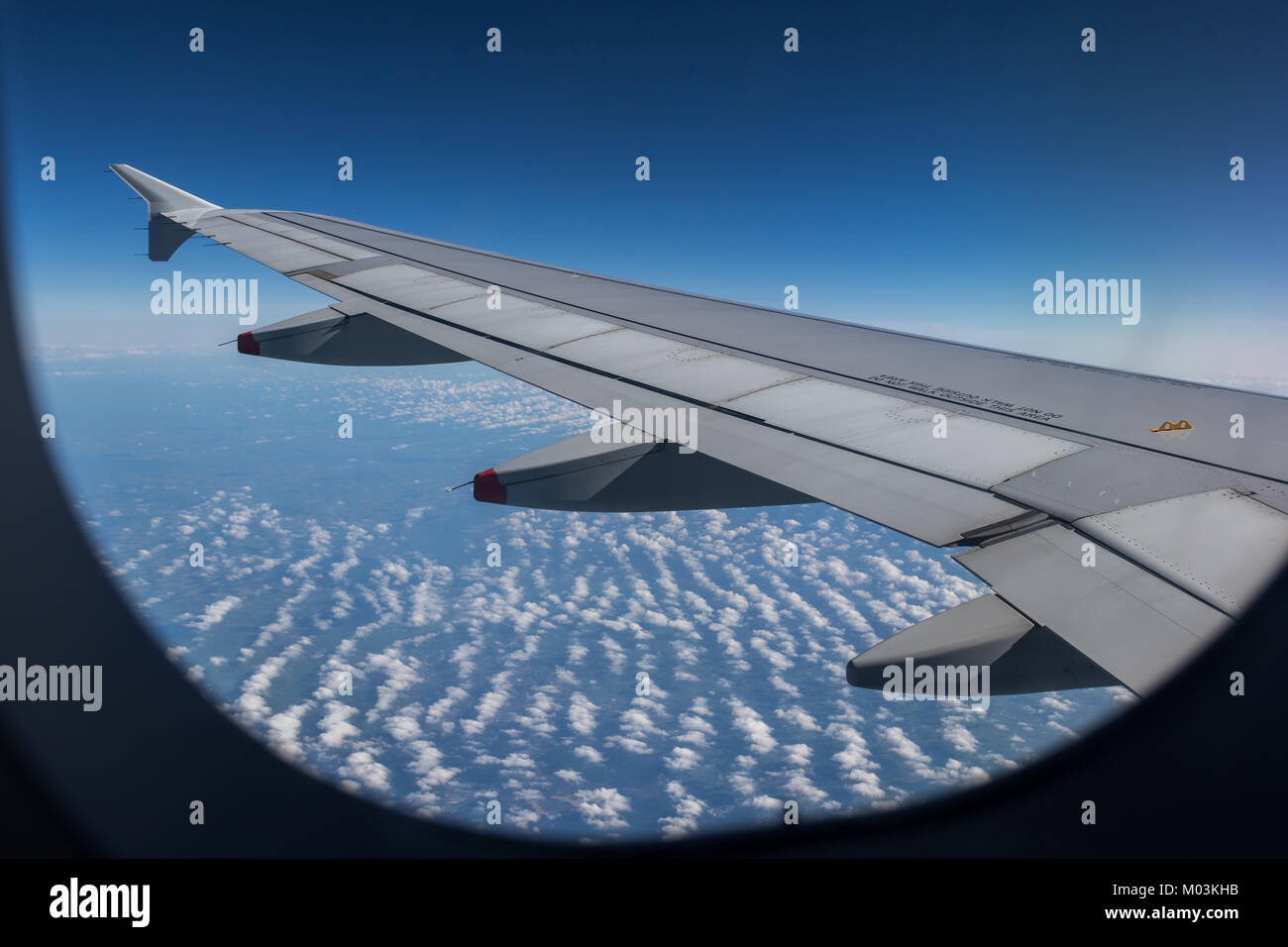 Wing of an airplane in flight seen from passengers window Stock Photo ...