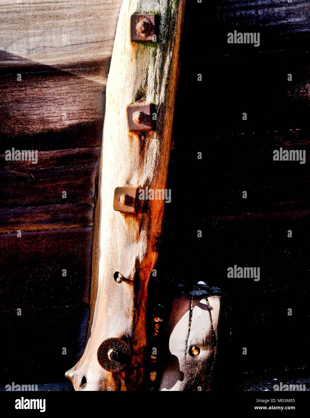 Wooden, weathered sea defence wall, three gnarled planks of wood ...