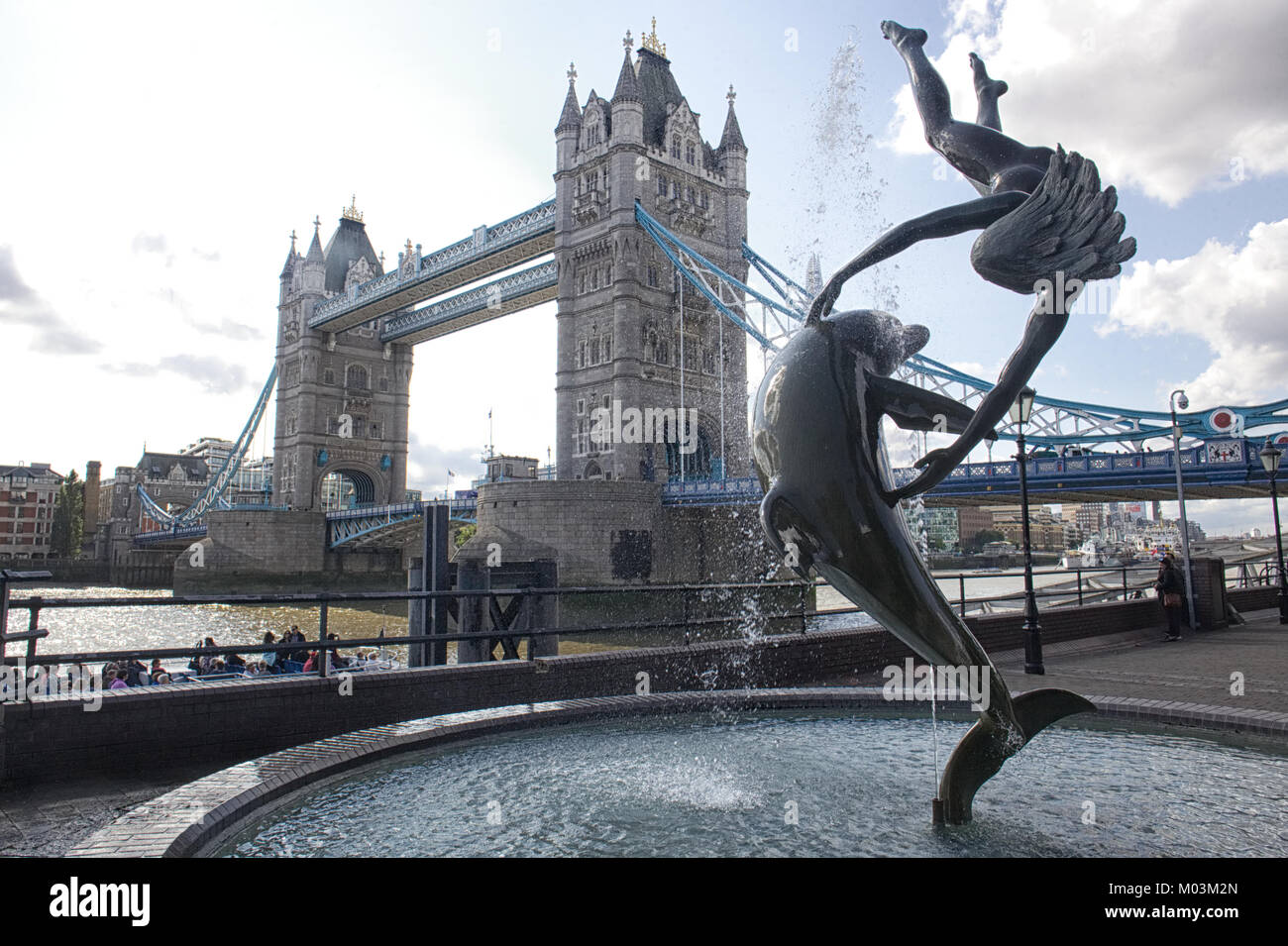 Girl with a dolphin fountain with tower bridge in the background Stock ...
