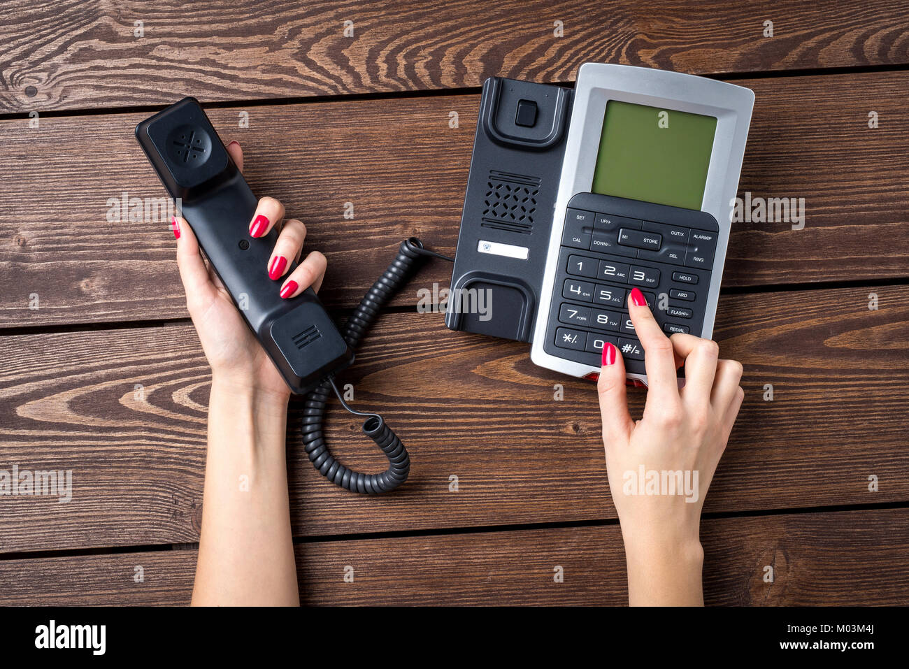 Woman using telephone Stock Photo - Alamy