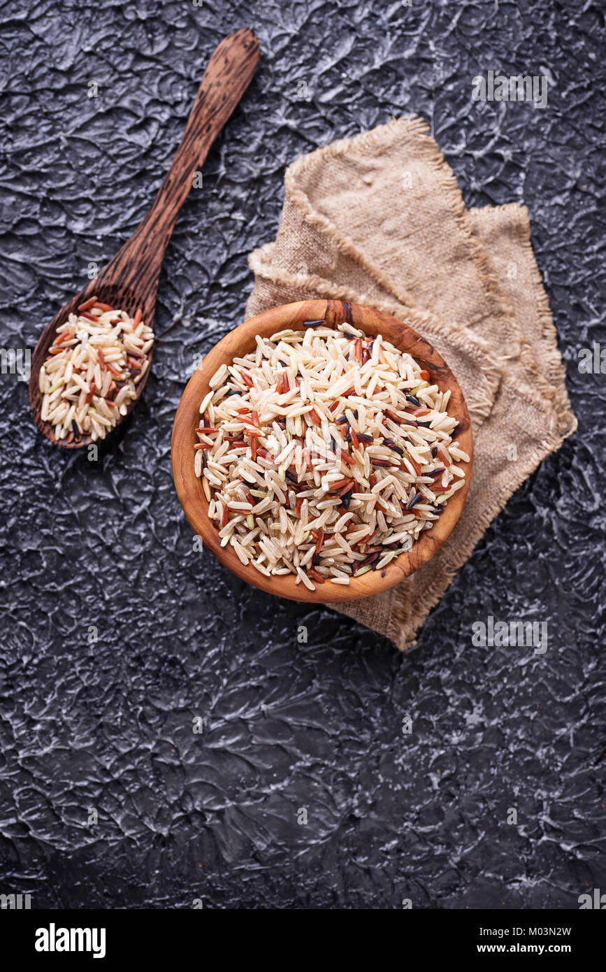 Mix of brown, red and wild rice in bowl. Selective focus Stock Photo ...