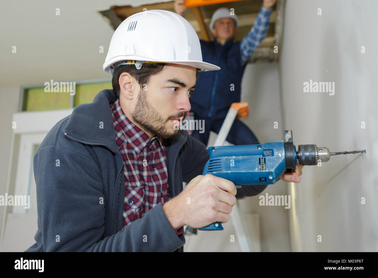 young man using power drill Stock Photo - Alamy