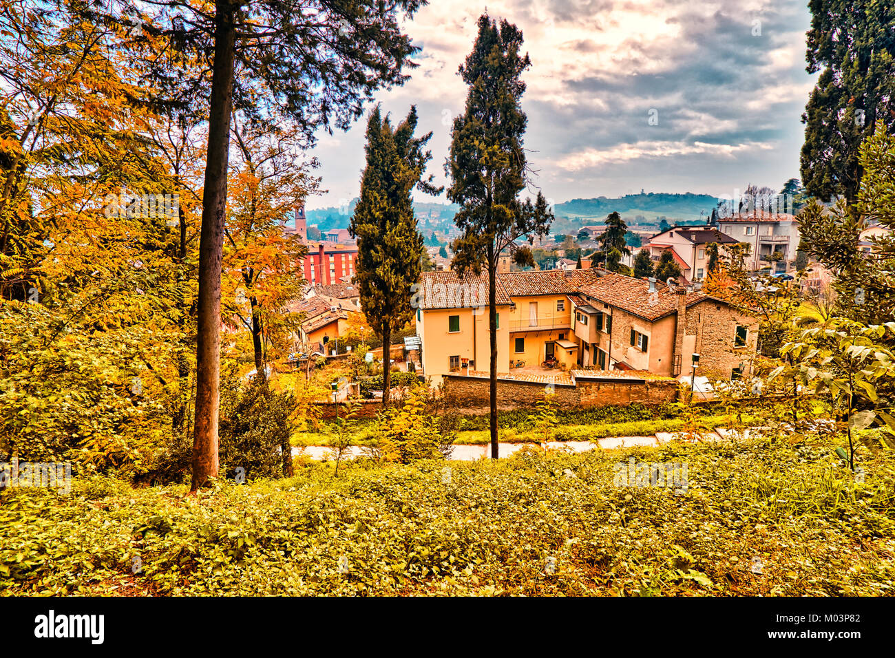 path in a green forest landscape setting near typical Italian village ...