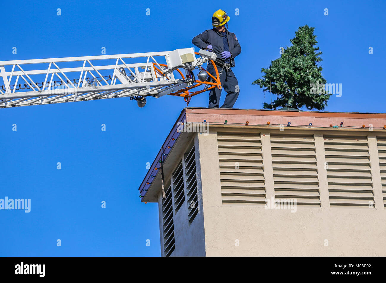 Firefighter Kevin Martin uses the ladder on the 105 foot Aerial fire ...