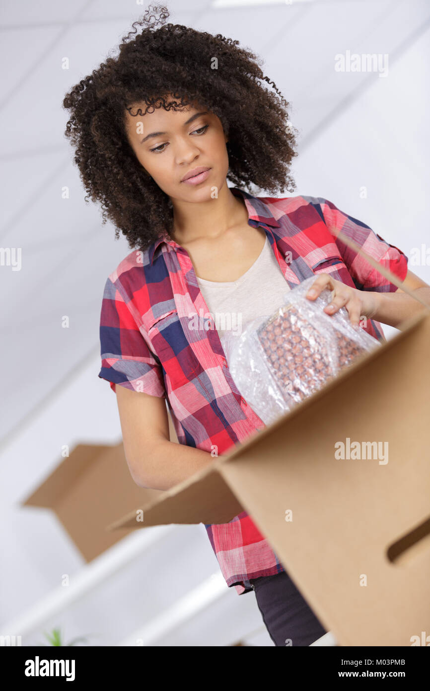 woman unpacking unboxing cardboard box Stock Photo - Alamy