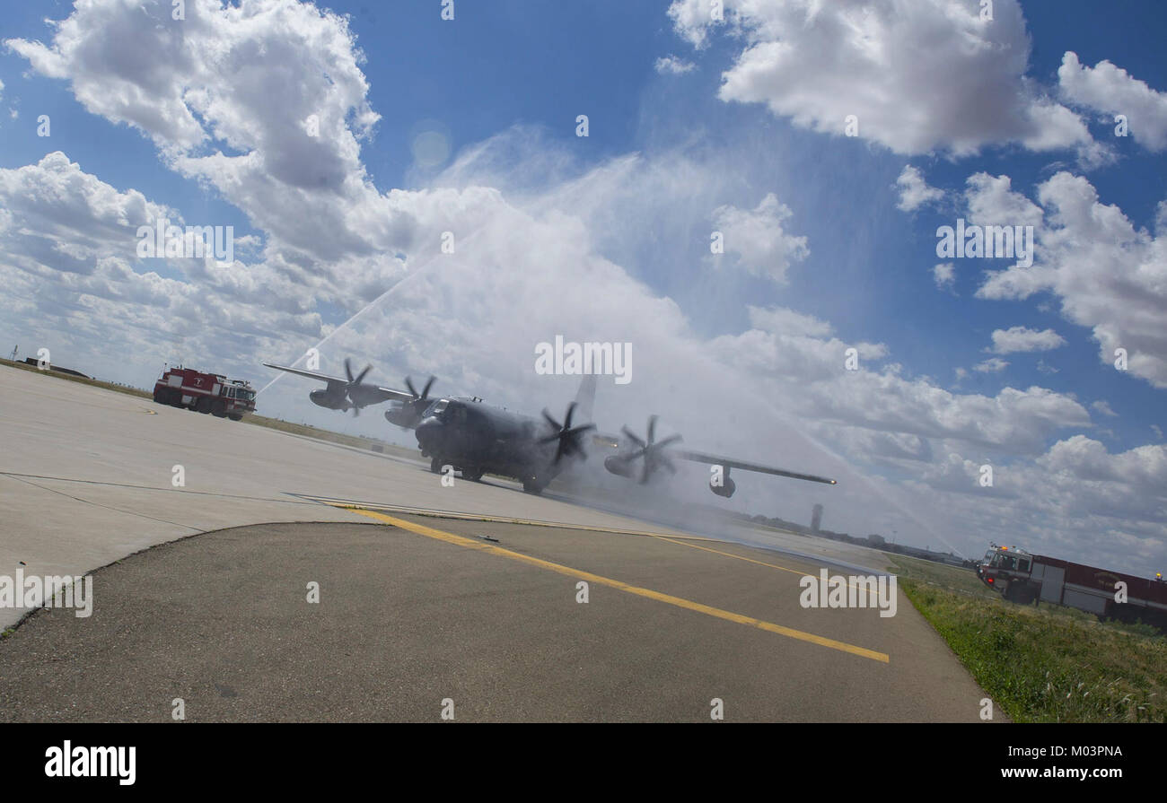 A MC-130J Commando II is sprayed by firetrucks, known as a “water ...
