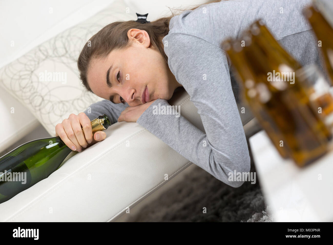 alcoholic addict woman lying on the sofa hangovered with bottles Stock ...