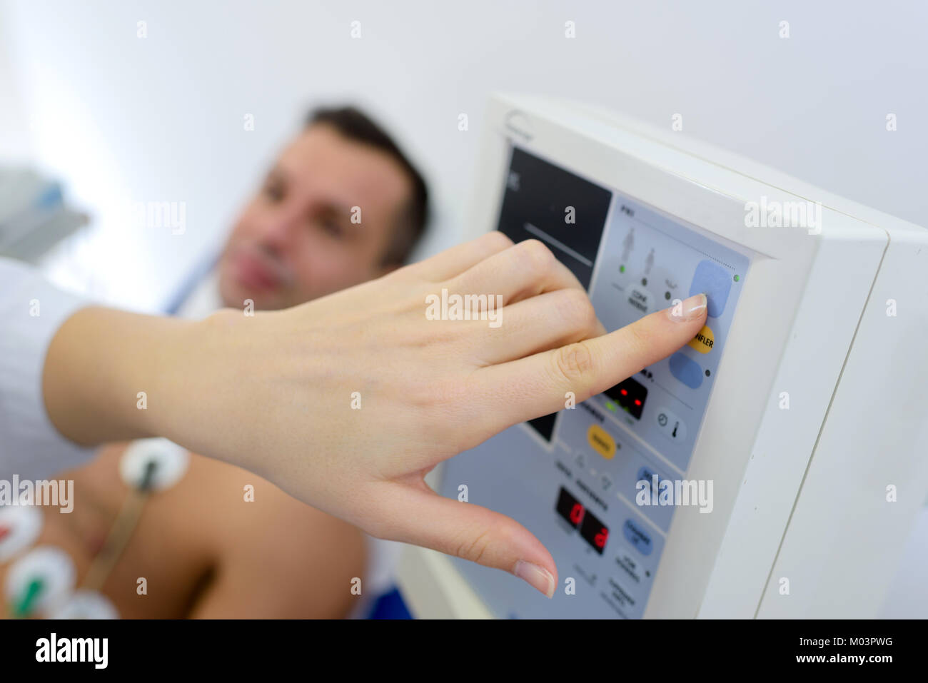 Nurse activating heart monitor Stock Photo - Alamy