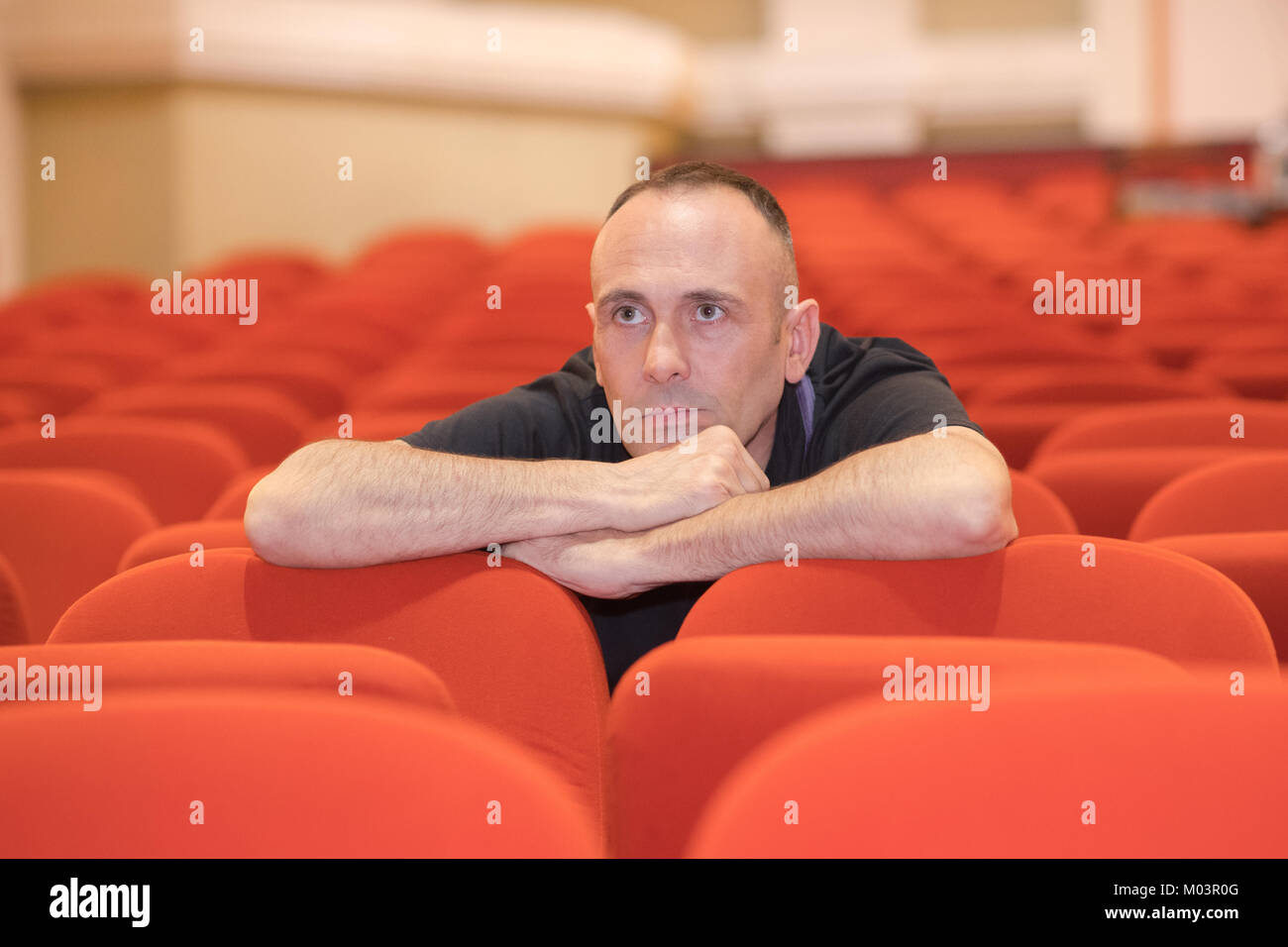 Man alone in auditorium Stock Photo - Alamy