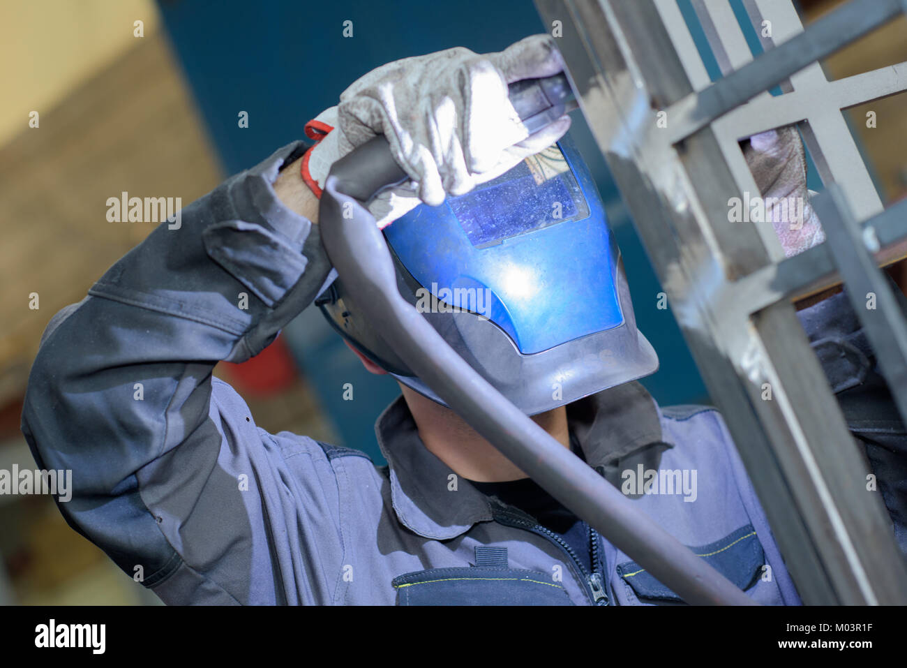 Workman welding metal structure Stock Photo - Alamy