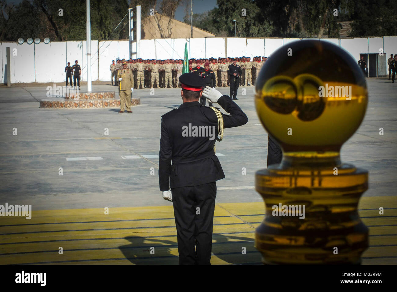 A Counter Terrorism Service Academy officer salutes the Iraqi flag ...