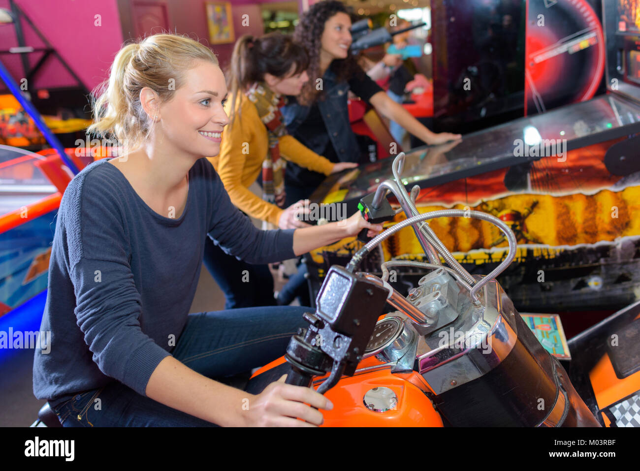 Woman on motorcycle arcade game Stock Photo - Alamy