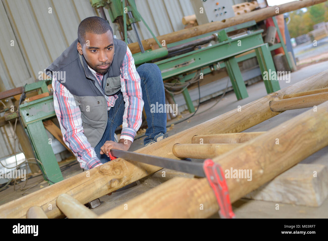 Man working in sawmill Stock Photo - Alamy