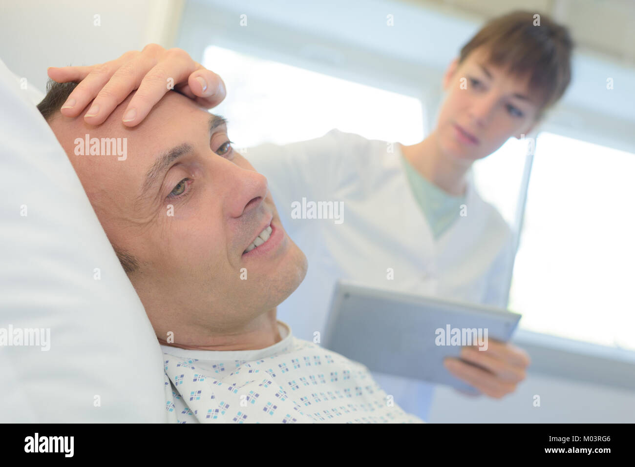 nurse checking patient temperature in hospital room Stock Photo - Alamy