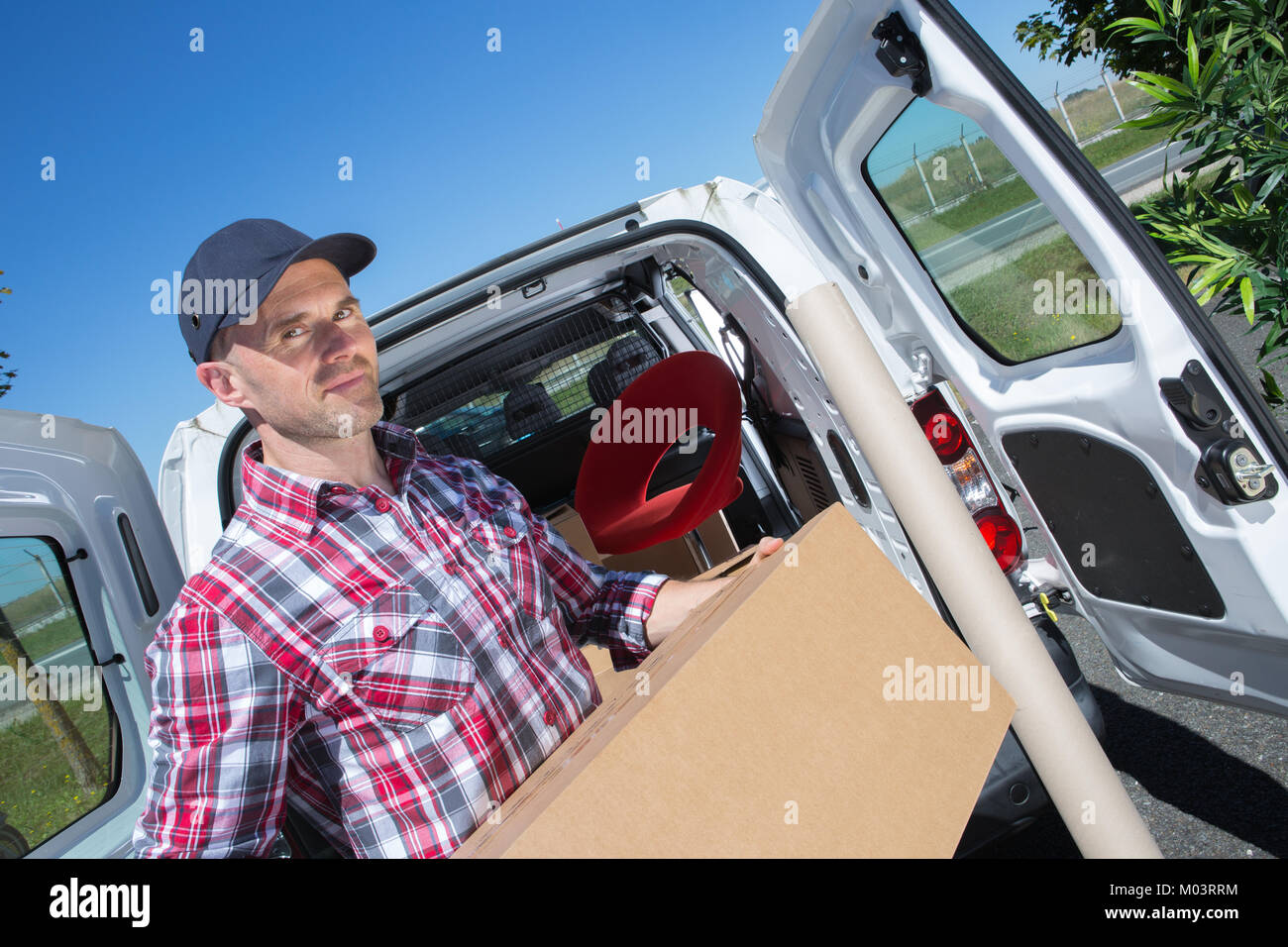 delivery man taking package from car Stock Photo - Alamy