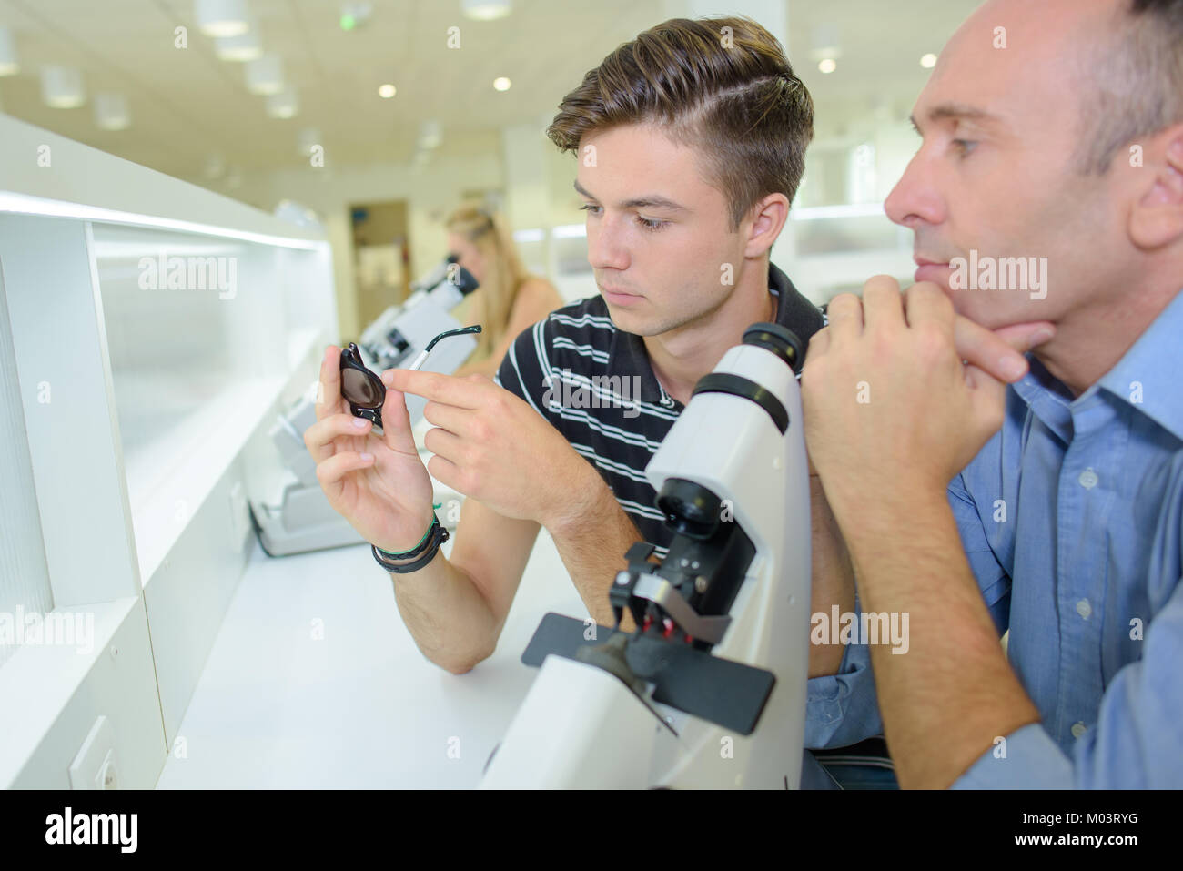 Young man looking at lens Stock Photo - Alamy