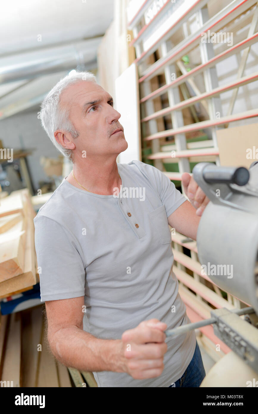 Carpenter using machinery Stock Photo - Alamy