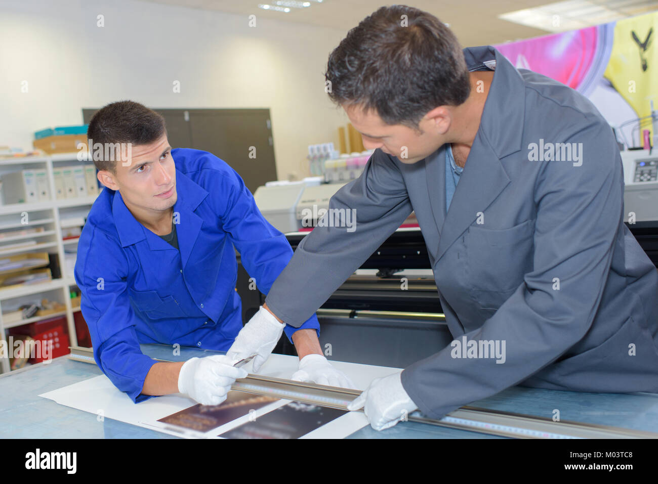 Two men creating a poster Stock Photo - Alamy