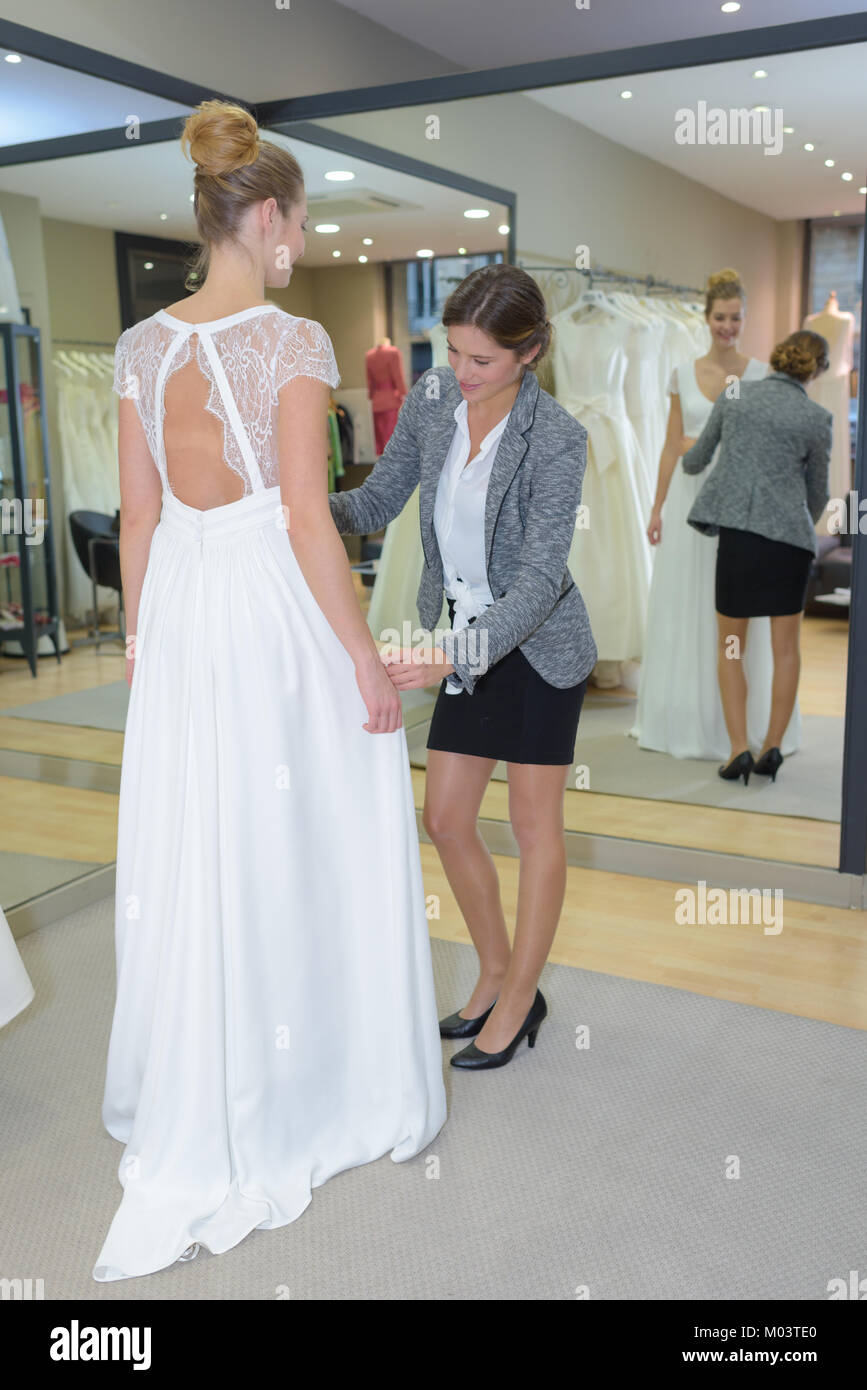 Woman having wedding dress fitting Stock Photo - Alamy