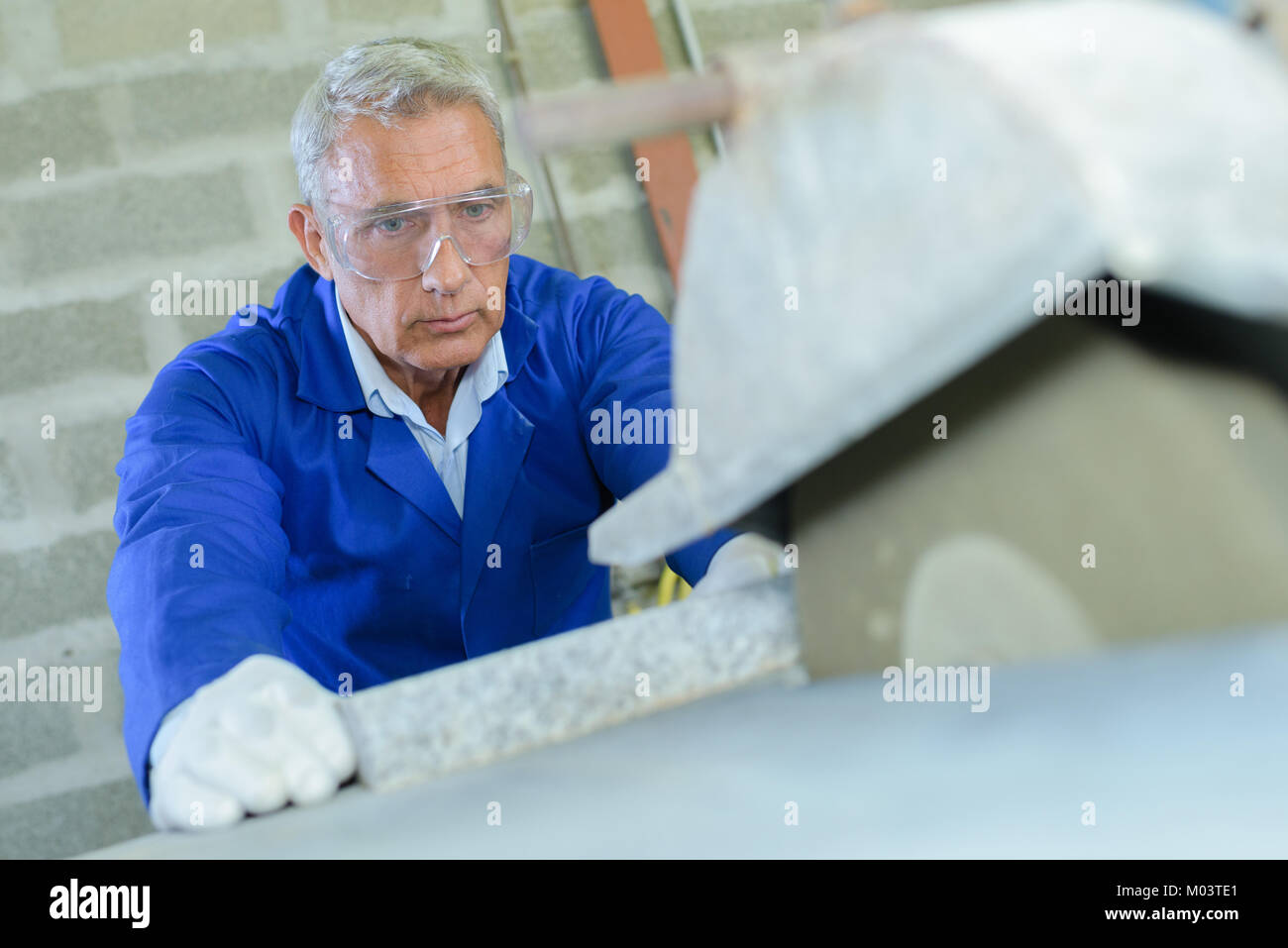 Mature man with slab of marble Stock Photo - Alamy