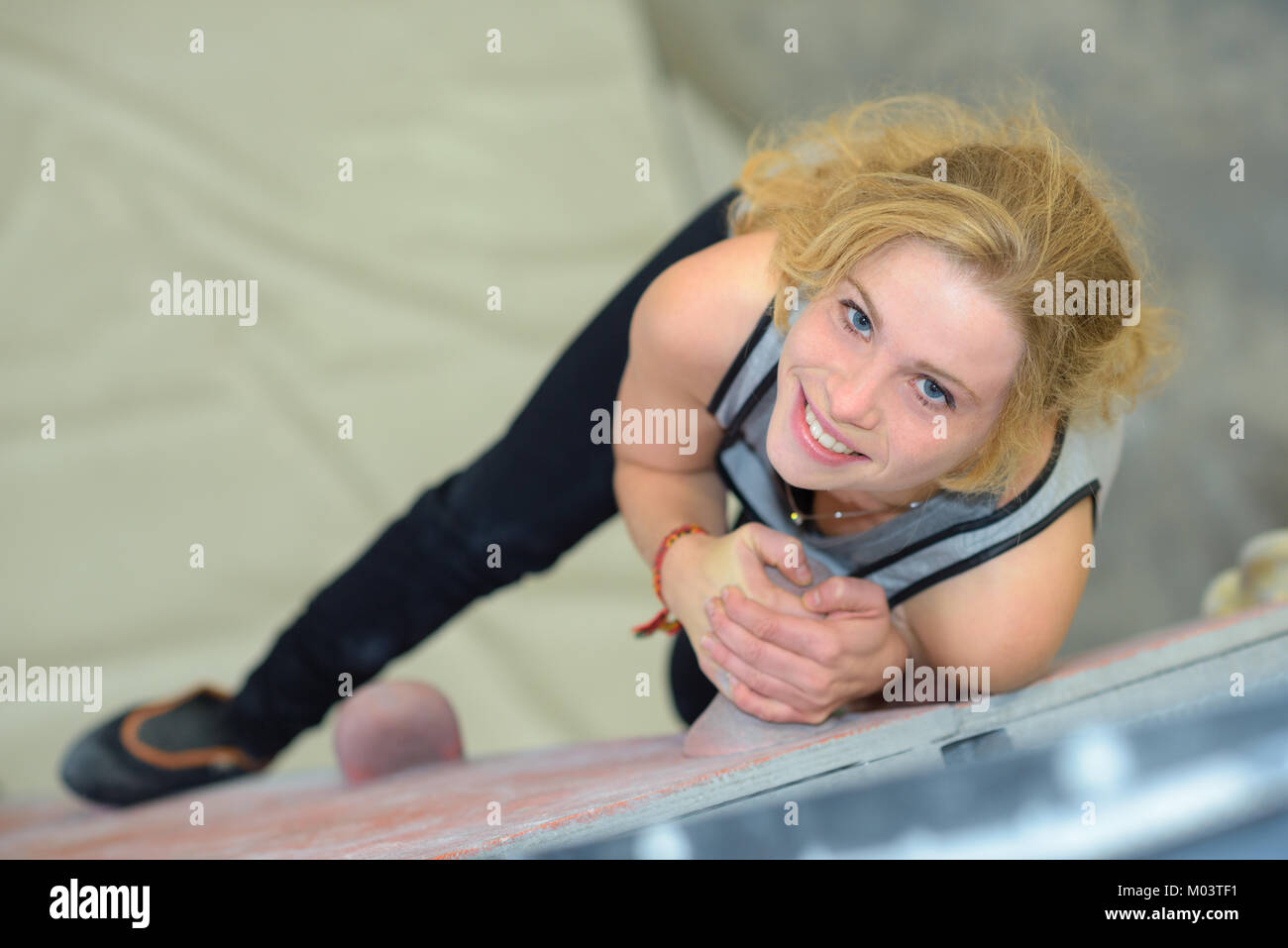 Downward view of woman on climbing wall Stock Photo - Alamy
