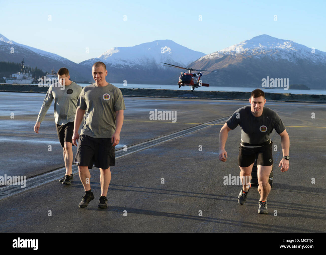 Coast Guard Petty Officer 2nd Class Stephen Scheren drags a 225lb sled ...