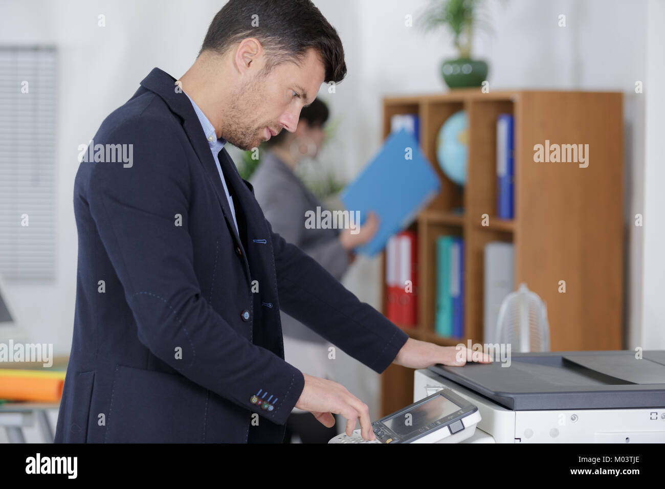 businessman using photocopy machine in office Stock Photo - Alamy