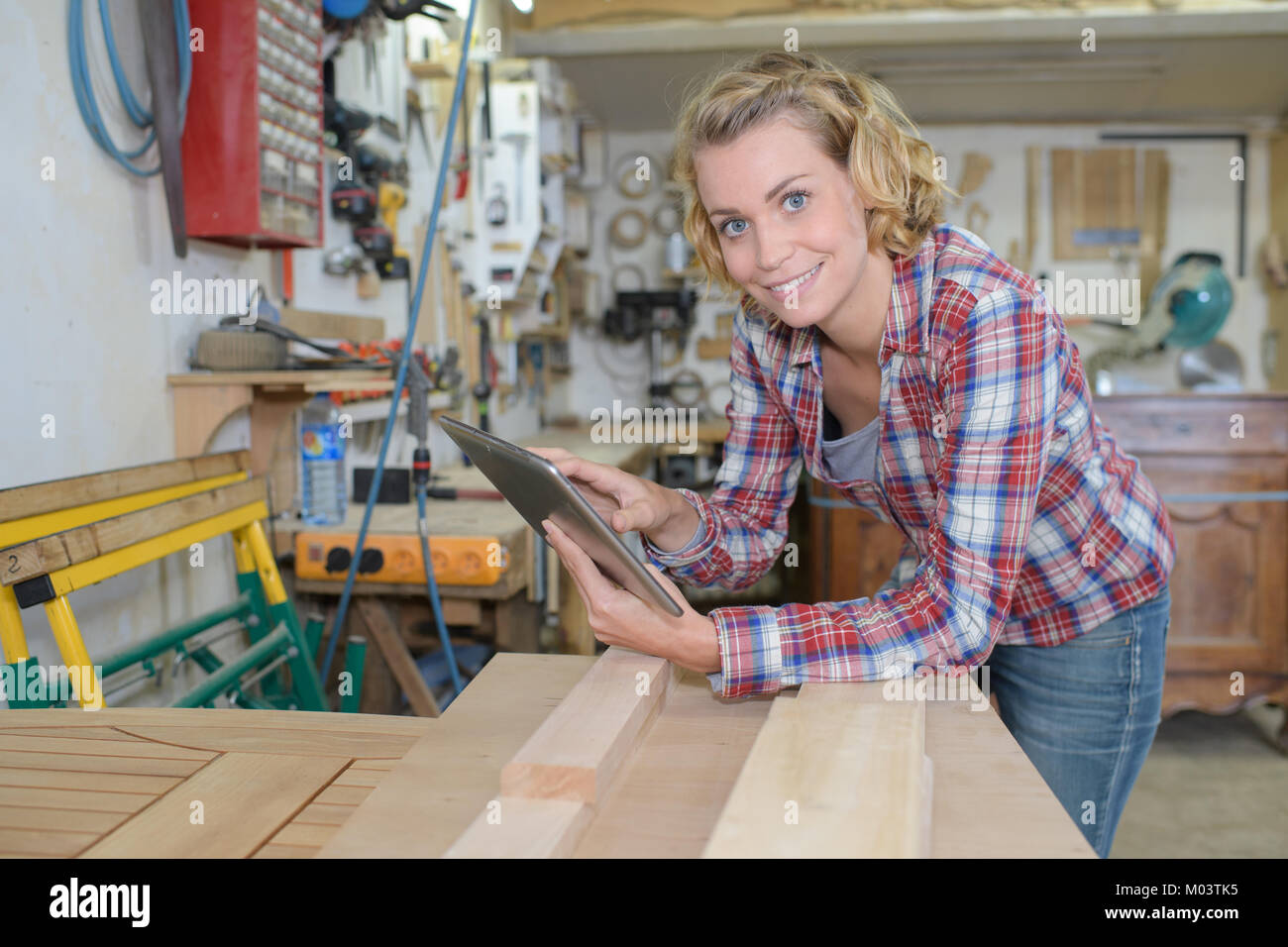 happy female carpenters with digital tablet in workshop Stock Photo - Alamy