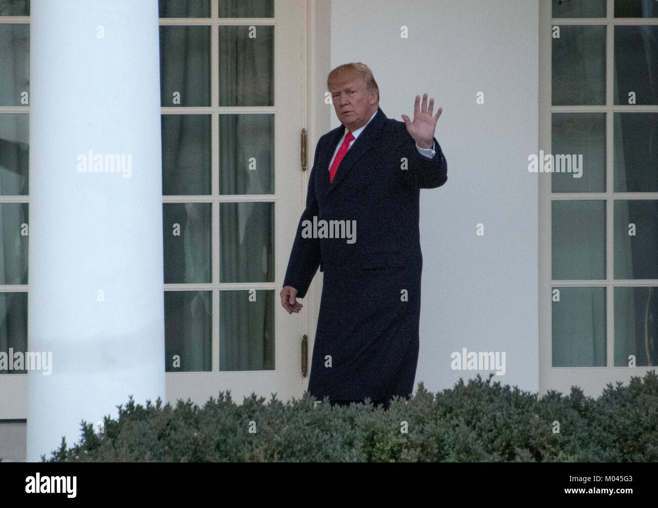United States President Donald J. Trump waves to the press as he walks ...